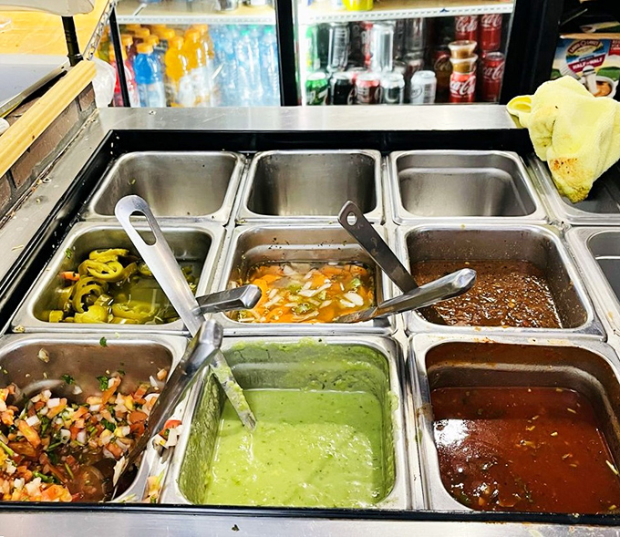 The salsa bar offers a rainbow of heat levels, from gentle whispers to full-throated flavor declarations. 