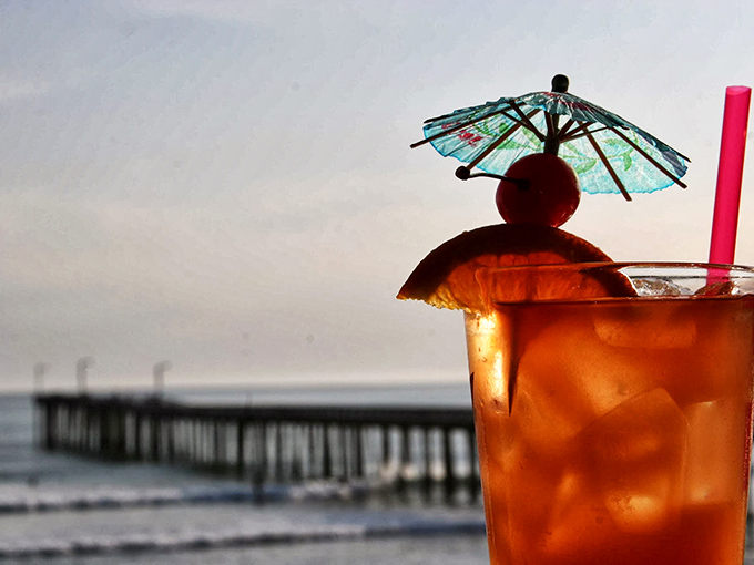 Nothing says "vacation mode activated" like a fruity cocktail with the pier in the background. Instant stress reduction in a glass.