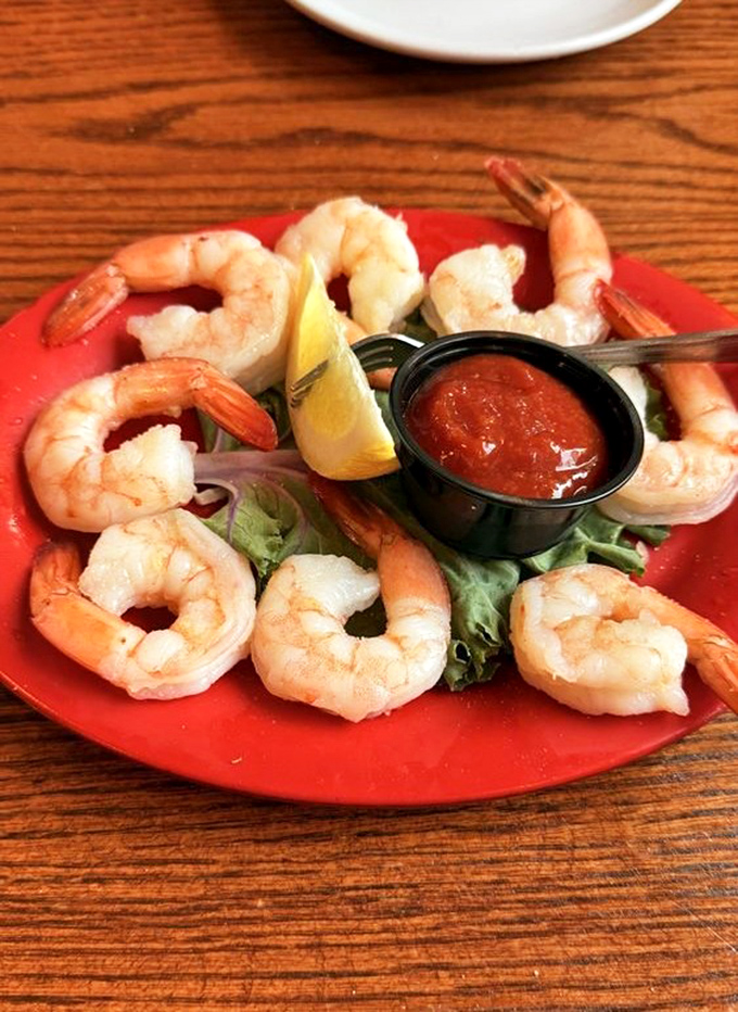 A shrimp cocktail that's all business – plump, perfectly cooked crustaceans arranged in a circle like they're planning something delicious.