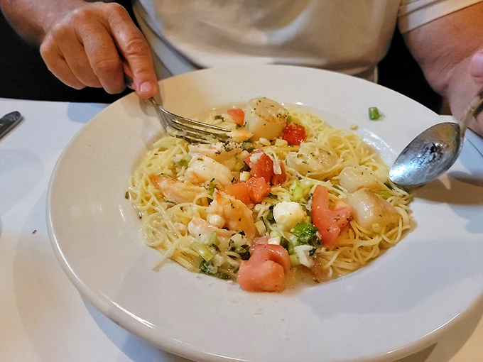 A pasta dish that doesn't skimp on seafood. Every twirl of spaghetti delivers a perfect ratio of shrimp, scallops, and fresh tomatoes.