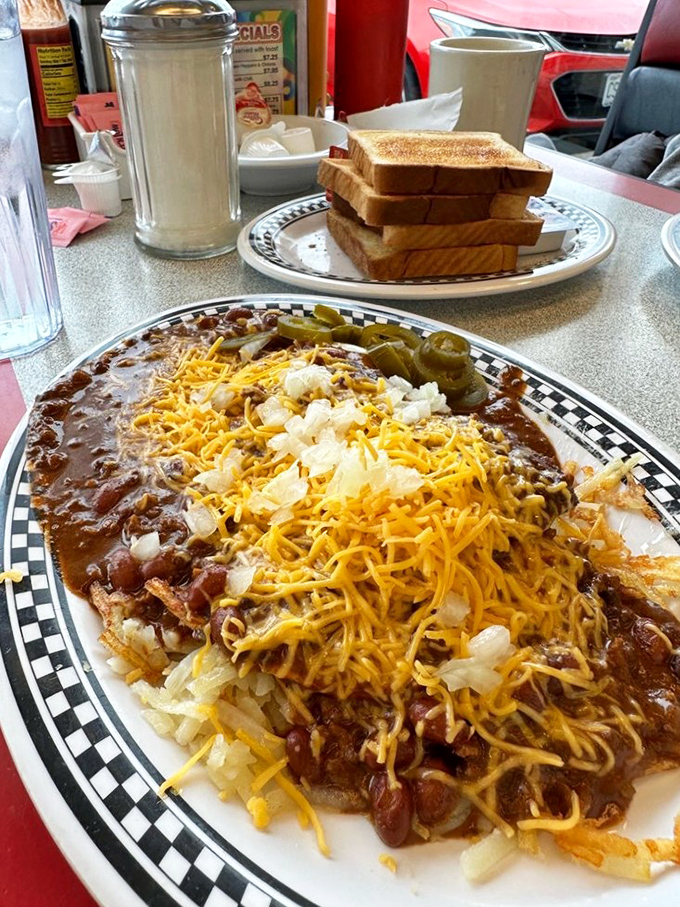 The legendary St. Louis Slinger: where chili, eggs, hash browns, and cheese unite in a glorious mess that's both hangover cure and hangover cause.