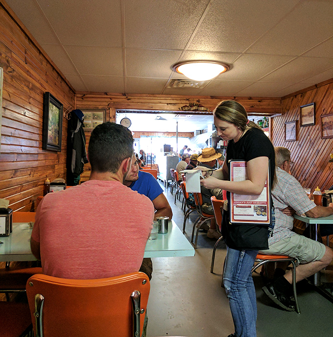In the warm wood-paneled dining room, servers navigate the space with the practiced grace of dancers who know every step by heart.