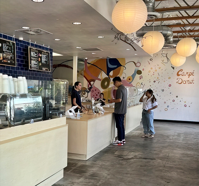 "Carpe Donut" indeed! The playful mural and friendly service create an atmosphere as welcoming as the aroma of fresh-fried dough.