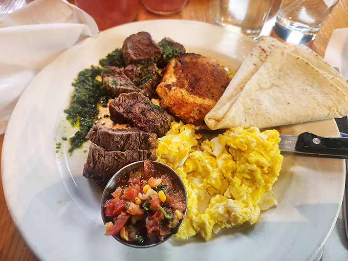 A plate that means business—sliced steak cooked to perfection, eggs sunny as a Virginia morning, and chimichurri that adds a verdant punch.