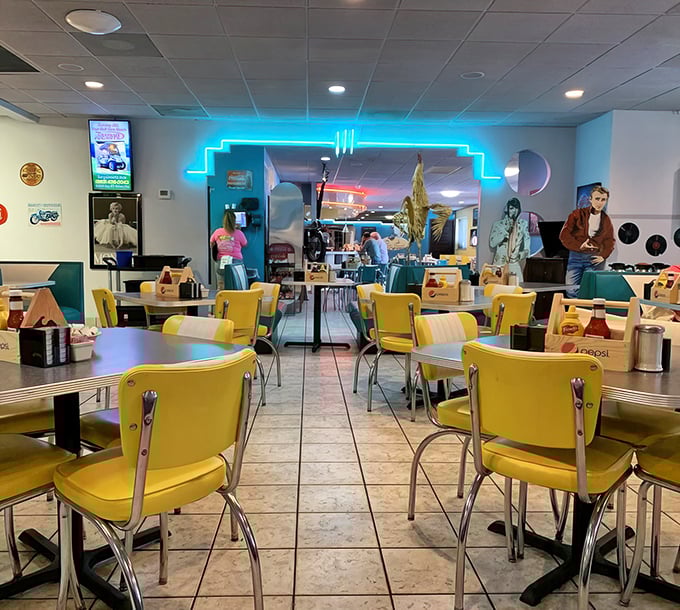 The neon archway divides the dining room like a portal between decades. Elvis would feel right at home in those booths.
