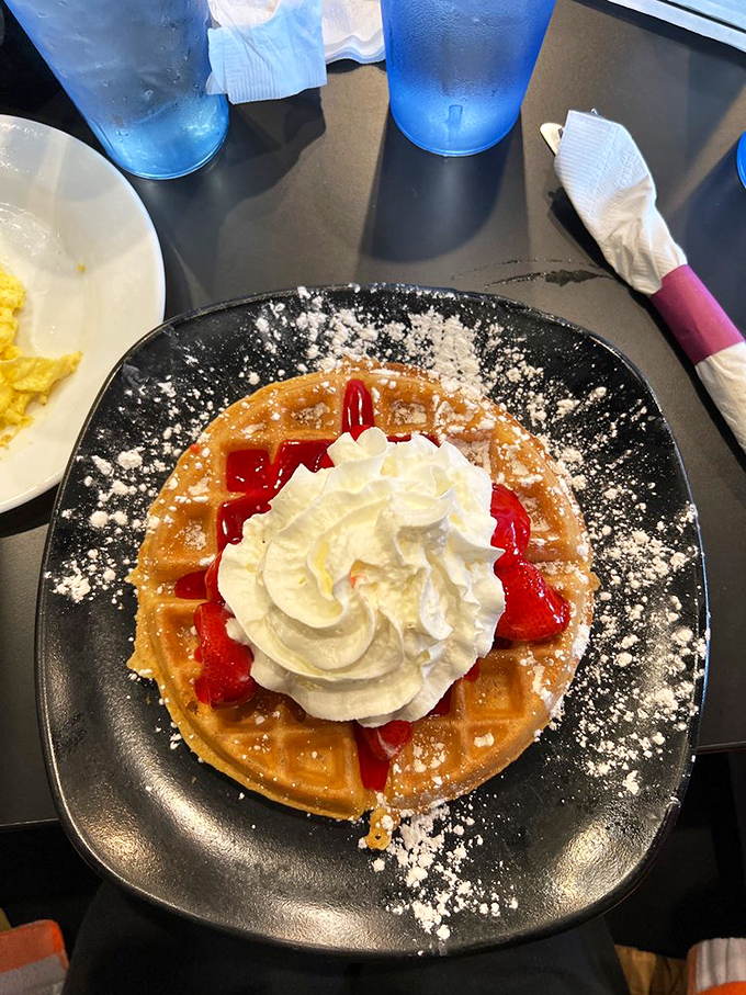 A strawberry waffle that makes you wonder why fruit salad even exists. That whipped cream mountain isn't excessive&mdash;it's necessary emotional support.