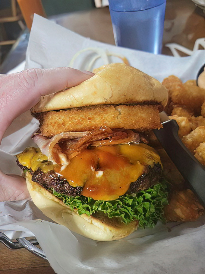 The burger architecture here deserves an award. That perfect stack of beef, cheese, and toppings is the skyscraper of sandwich engineering.