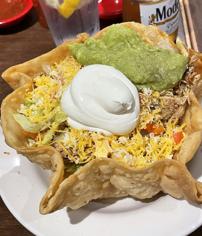 The tortilla salad bowl cradles fresh greens and toppings like edible architecture, proving vegetables can be absolutely show-stopping too.