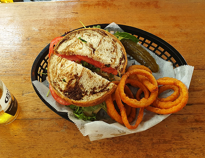 This sandwich isn't trying to win a beauty pageant, but the rustic presentation on a wooden table speaks the universal language of "get in my belly now."