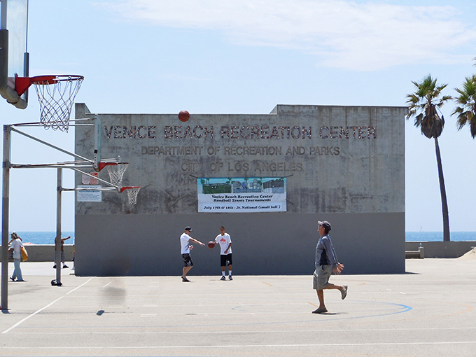 Even basketball feels more cinematic in Venice Beach, where pickup games happen with ocean soundtrack and palm tree lighting.