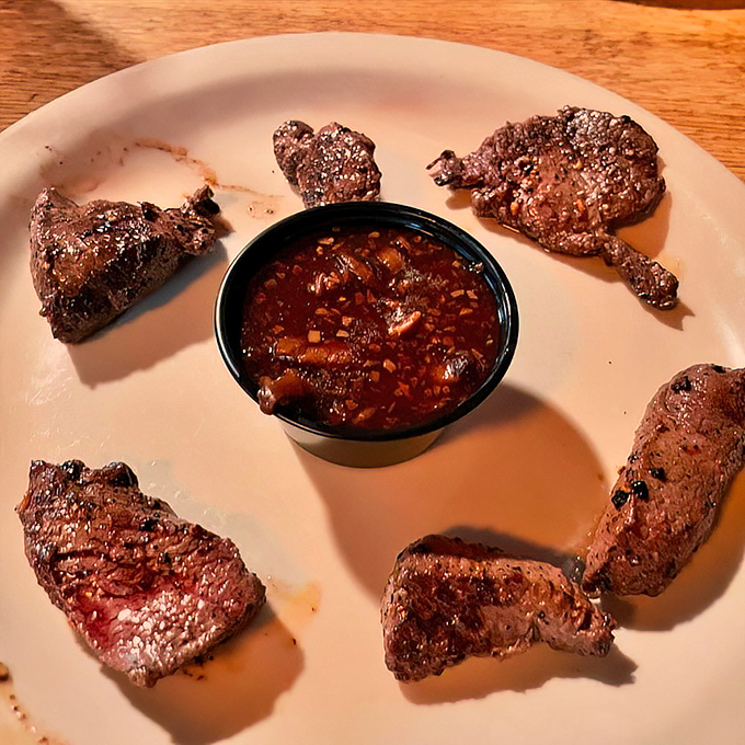 Venison bites arranged around house sauce&mdash;a carnivore's dream that proves wild game doesn't need fancy preparation when the quality speaks for itself.