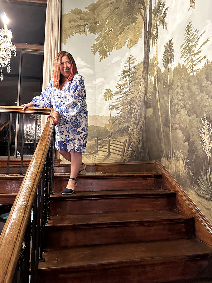 The grand staircase, where every step is accompanied by a sweeping mural that turns a simple descent into a cinematic moment.