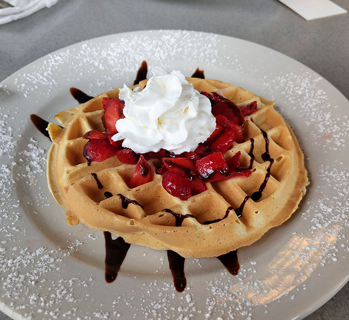A waffle that's both canvas and masterpiece, with strawberries and whipped cream playing the starring roles in this breakfast drama.