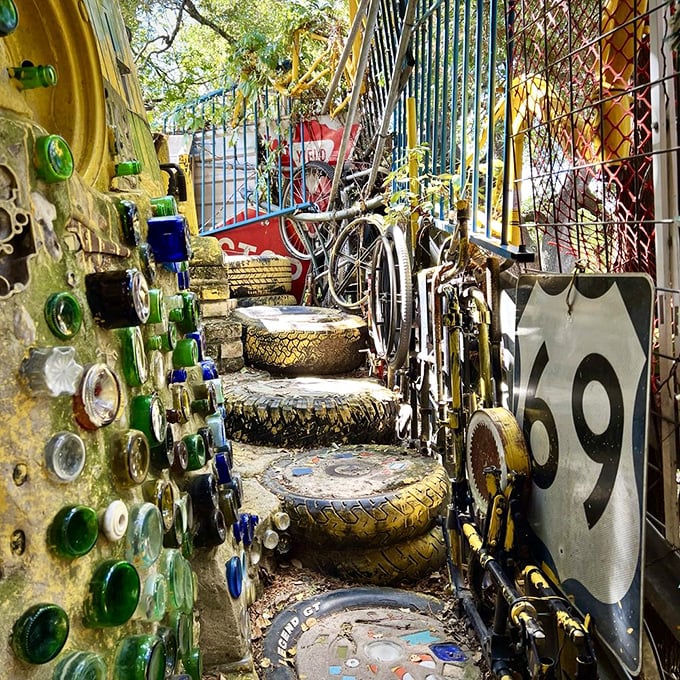 A pathway lined with embedded bottles catches the sunlight like stained glass windows in this most unconventional of cathedrals.