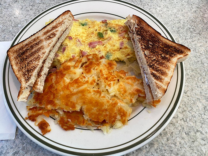 Breakfast perfection on a plate: a Western omelet with perfectly crisp toast that proves simple food done right is sometimes the most satisfying meal of all.