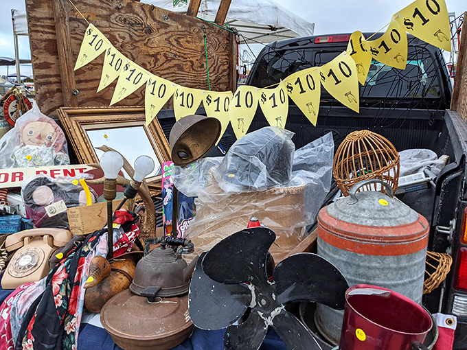 Bargain banners flutter above a pickup truck treasure trove. One person's "everything must go" becomes another's "everything must have."