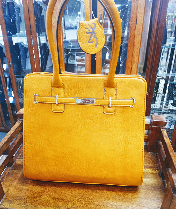 This mustard-yellow handbag isn't just an accessory—it's a statement piece that survived fashion's fickle cycles to become timeless.