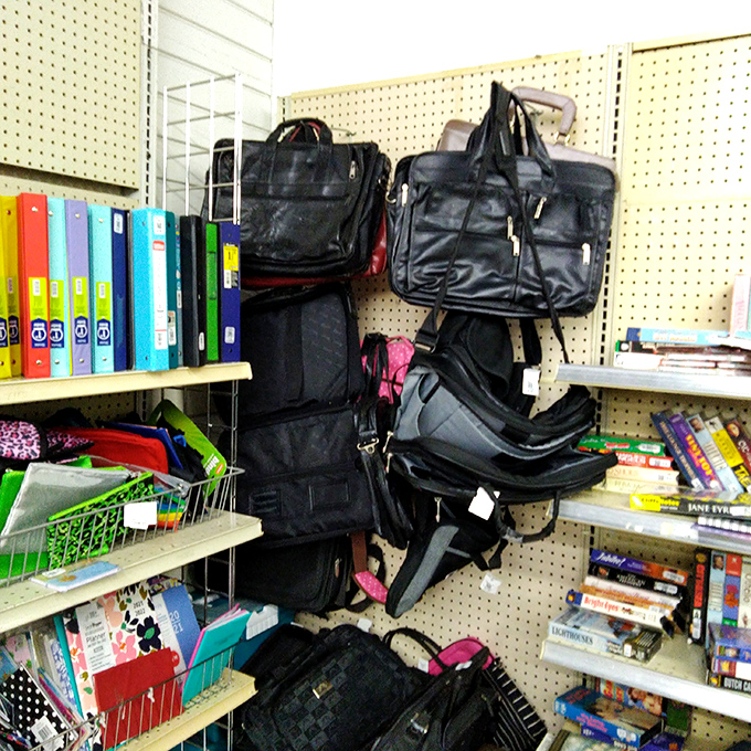 Business meets bargain in the bag section, where briefcases and backpacks hang like bats, waiting for their next professional adventure.