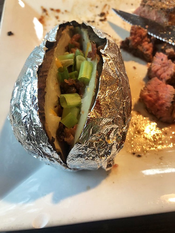 Not just any baked potato&mdash;this foil-wrapped treasure comes loaded with green onions, ready to play the perfect supporting role to your steak.