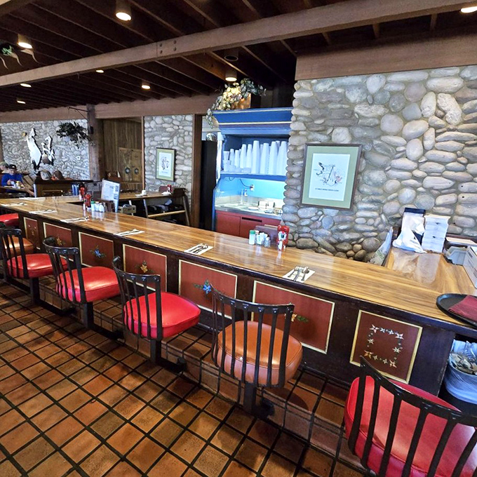 The counter seating area offers a front-row view to roadside dining nostalgia, complete with European-inspired crests that remind you this isn't just any highway restaurant.