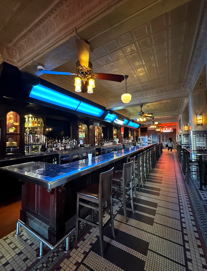 The bar stretches toward infinity, with a blue glow that suggests you've entered the cocktail equivalent of the Starship Enterprise.