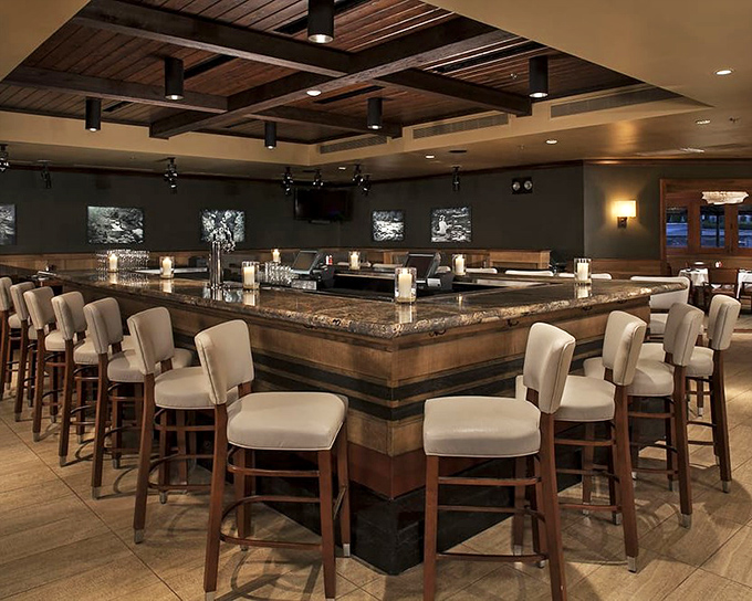 The bar beckons with promises of perfectly crafted cocktails and conversations that last well into the evening.