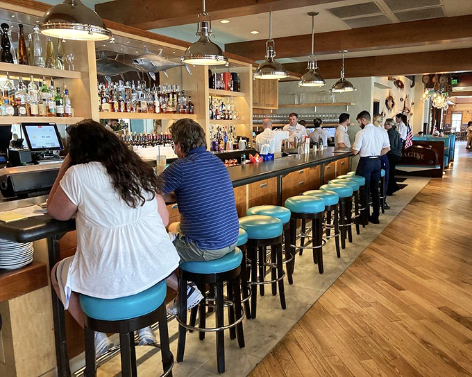 The bar where strangers become friends and friends become regulars. Those blue stools have heard some stories.