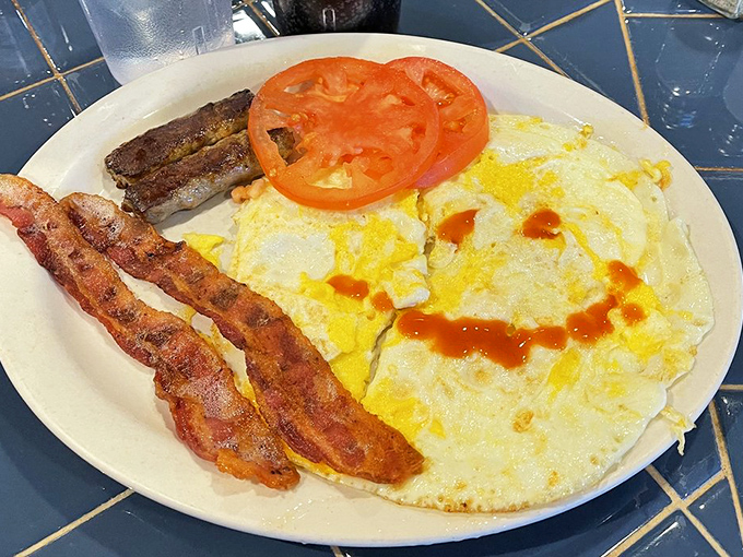 Eggs, bacon, and hot sauce&mdash;the holy trinity of breakfast, presented without apology or unnecessary garnish. Just as it should be.