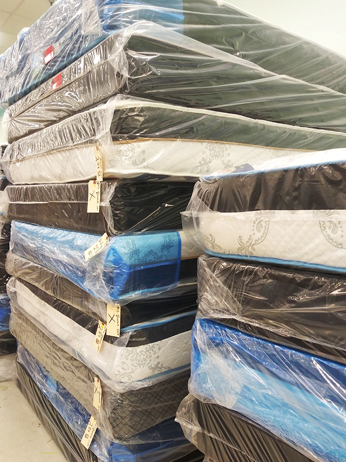 The mattress mountain: stacked dreams and good night's sleep at fraction-of-retail prices. Someone's perfect bedding match is hiding in this textile tower.