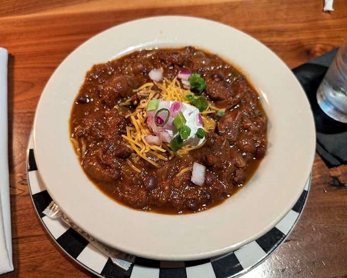 This isn't your camping trip chili &ndash; it's a rich, complex stew topped with cheese, onions, and a dollop of sour cream.