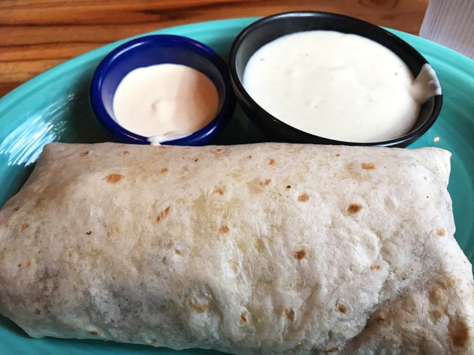 This breakfast burrito isn't just a meal, it's a commitment. Wrapped tighter than holiday gifts, with sauces standing by for the flavor dunking to come.