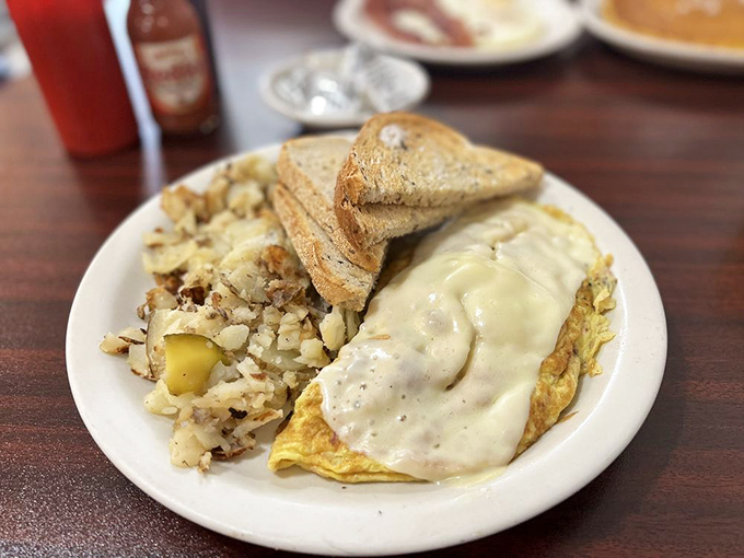 An omelet draped in country gravy isn't just comfort food&mdash;it's a warm hug from the Midwest that stays with you all day.