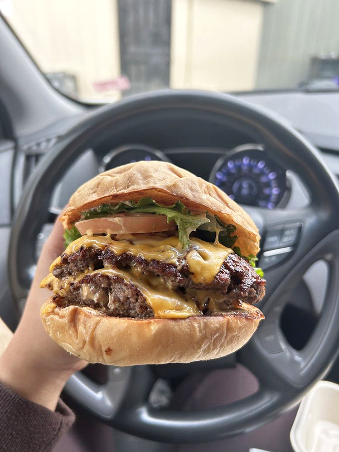 Car dashboard dining at its finest. This burger doesn't care about your upholstery&mdash;it demands to be devoured immediately.