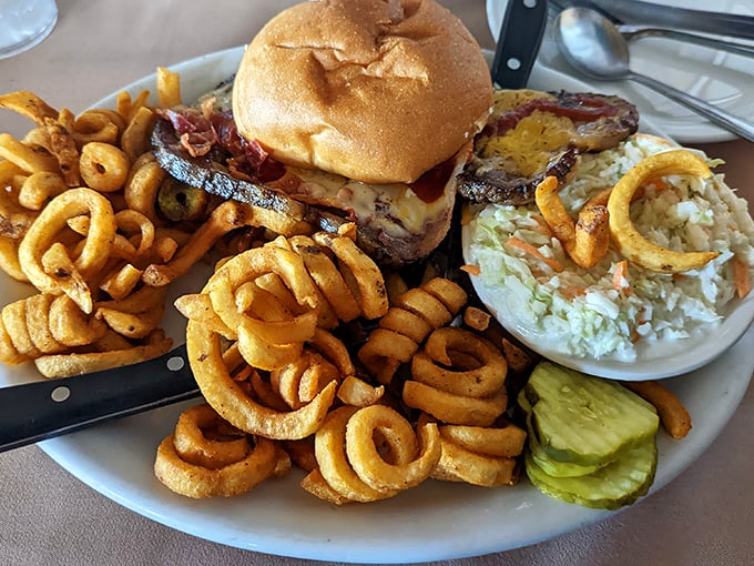 A burger surrounded by a moat of curly fries so perfect, you'll want to build tiny bridges just to reach them.