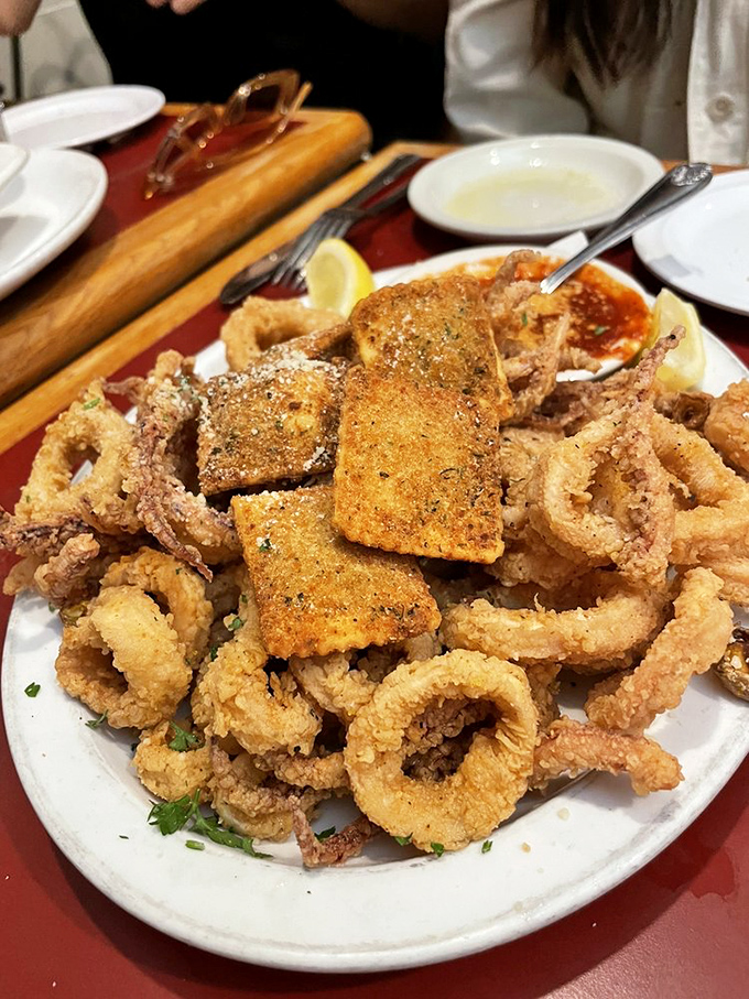 A mountain of perfectly crispy calamari and ravioli with marinara sauce standing by - the Italian version of "surf and turf" that's impossible to resist.