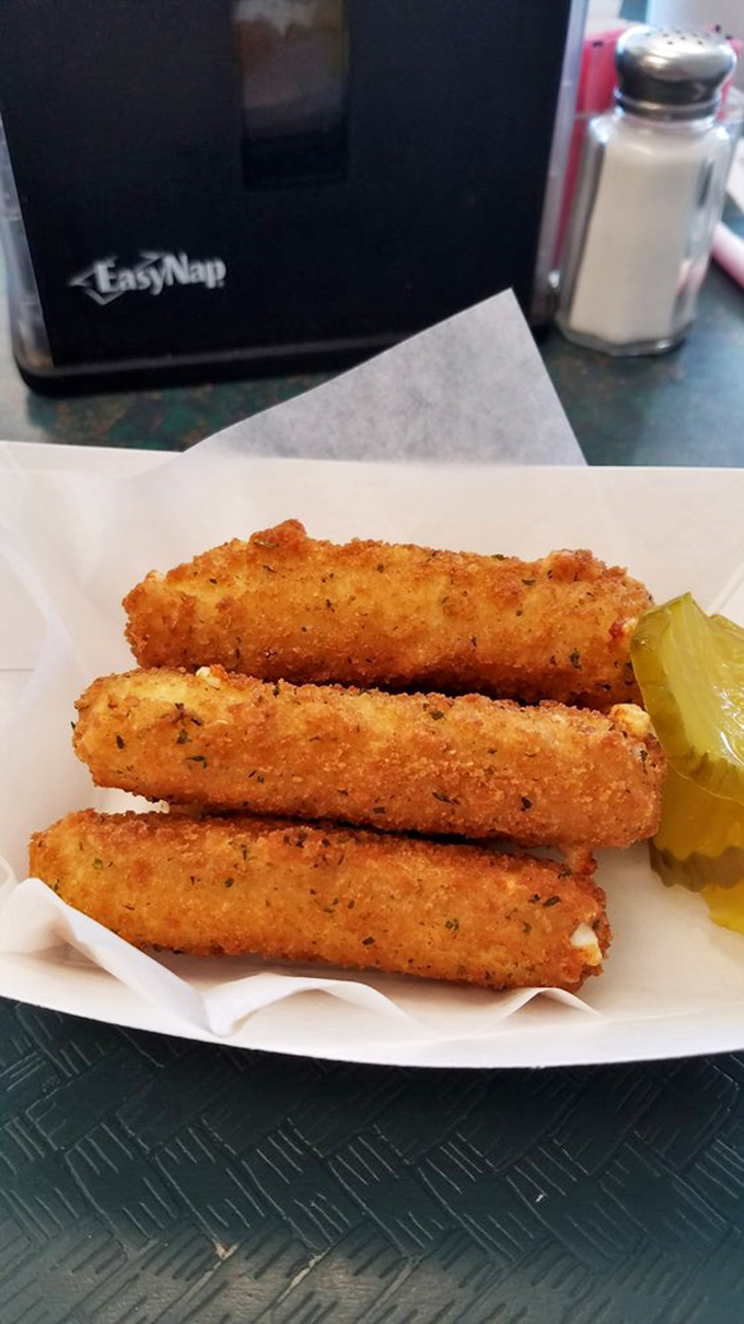 Cheese sticks that shatter with satisfying crispness, revealing molten interiors. That pickle slice isn't just garnish&mdash;it's the perfect acidic counterpoint to dairy decadence.