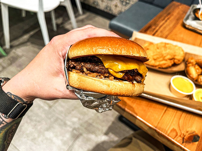 This isn't just a cheeseburger&mdash;it's a work of art. The melted cheese cascading over those crispy edges is what burger dreams are made of.
