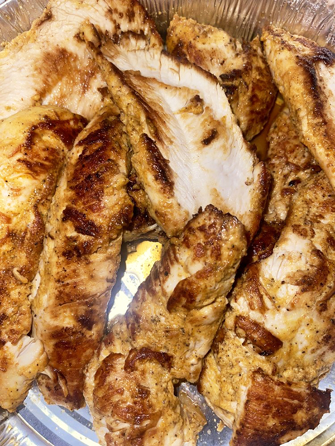 Seasoned, grilled chicken that looks like it's been kissed by fire gods. This isn't just protein&mdash;it's a masterclass in marinade.