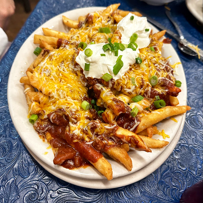 Chili cheese fries that blur the line between appetizer and life-altering experience. Diet plans come here to die happy deaths.