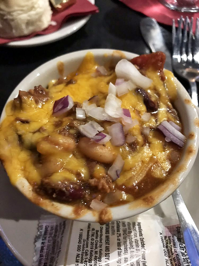 A bowl of hearty chili topped with melted cheese and diced onions&mdash;winter comfort that works even when you're not snowed in.