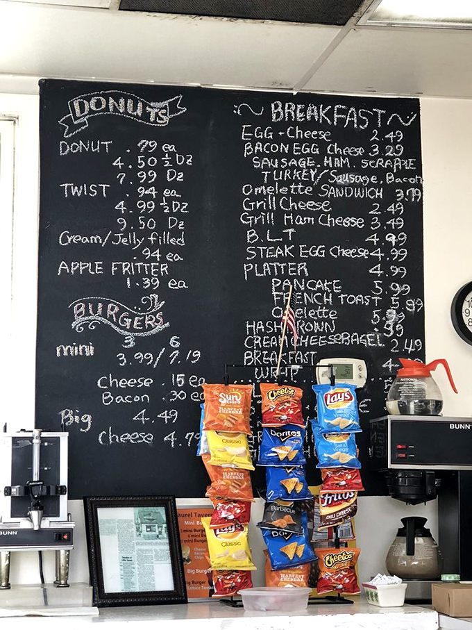 The chalkboard tells all: donuts, burgers, and breakfast classics with prices that won't require a second mortgage. Democracy in menu form.