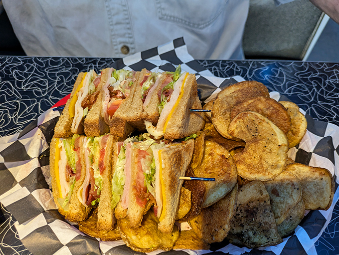 The club sandwich—stacked higher than my college textbooks—with layers of fresh ingredients and house-made chips that make you forget all about mass-produced snacks.