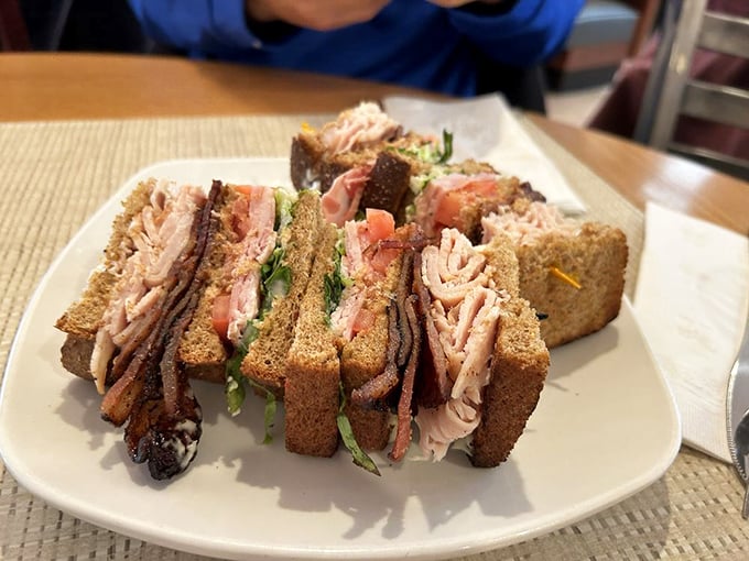 This club sandwich isn't just stacked—it's engineered for maximum flavor delivery with every architectural layer.