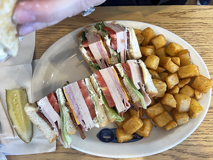This club sandwich has more layers than a Tennessee Williams play, with home fries that could make a potato farmer weep with joy.
