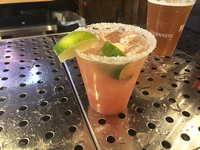 A cocktail with a salt rim that's dressed better than most people at formal events. The lime wedges aren't just garnish&mdash;they're essential supporting actors.