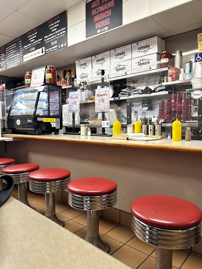 Classic diner counter seating with those perfect red stools &ndash; the front-row seats to the sandwich-making spectacle.