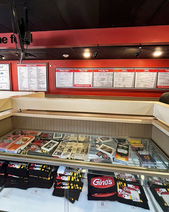 Where burger dreams become reality. The ordering counter displays Gino's history and merchandise, proving some places earn loyal fans through decades of consistent deliciousness.