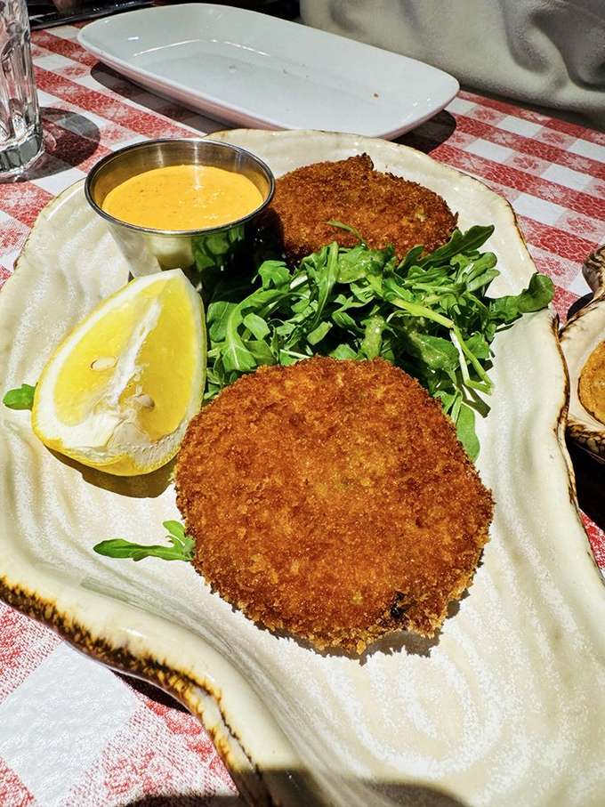 Golden-crusted crab cakes that achieve the impossible balance: minimal filler, maximum flavor, and a saffron aioli worth bottling and taking home.