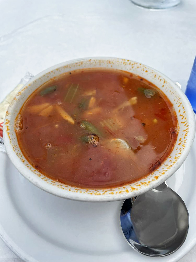 This isn't just soup&mdash;it's a seafood sanctuary in a bowl, brimming with chunks of crab and vegetables in a tomato-based broth.