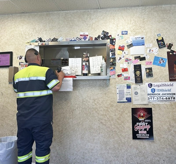 The universal language of barbecue: a worker in high-vis placing an order, proving good BBQ transcends all professional boundaries.
